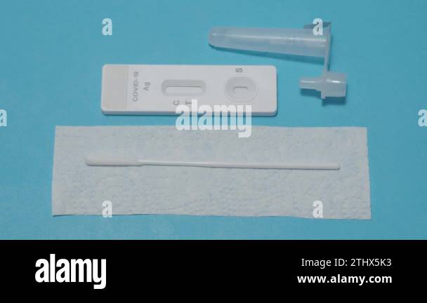 POV of Man hands using Rapid antigen test kit or ATK and blue ...