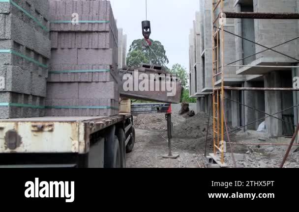 Lifting concrete block with crane at construction site Stock Videos ...
