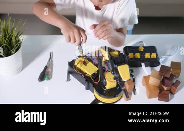Child learning repairing getting lesson control robot arm, Happy Asian ...