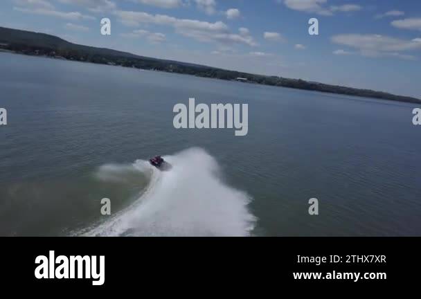 more young people race on the water with sports motorcycles. They surf ...