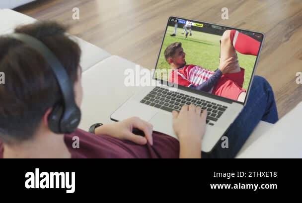 Video of person sitting on the couch and watching football match on ...