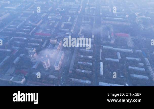 Epic gray smog is visible at sunset over the city. Aerial view from the ...