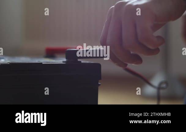 Mens hands disconnect the charger from the car battery Stock Video ...