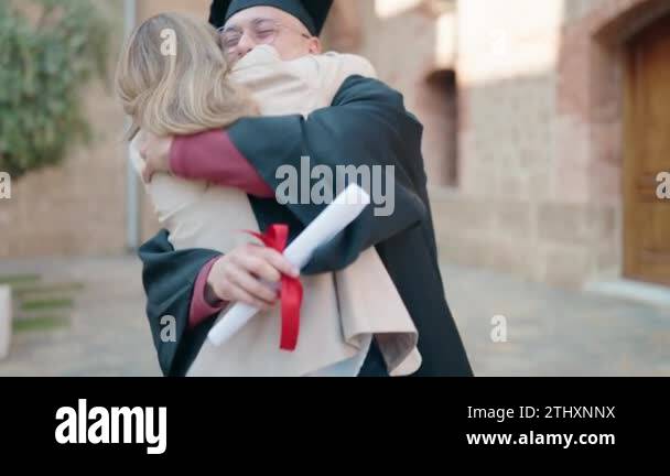 Man And Woman Mother And Son Hugging Each Other Celebrating Graduation