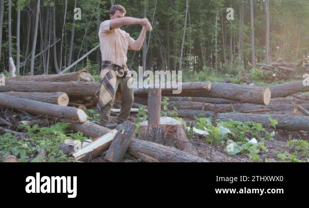 active man learning to cut wood trunks Slow motion. athletic guy ...