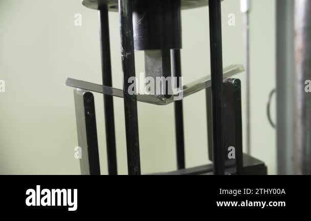 Broken plastic sheet under modern press. Laboratory checking level of ...