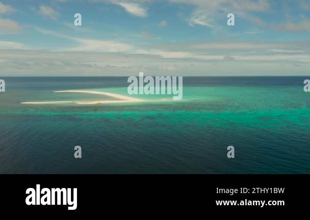 Sandy white island with beach and sandy bar in the turquoise atoll ...