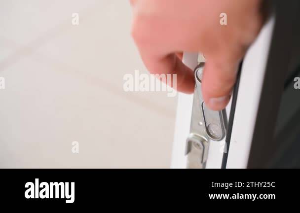 The mechanism of blocking of shutters of plastic doors. The hand snaps ...