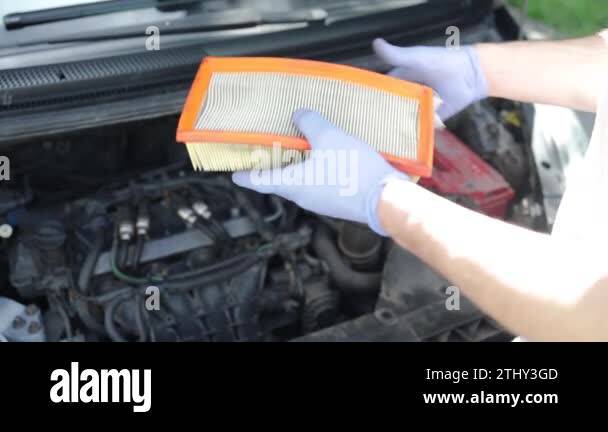Replacing the car's air filter with a new one, mechanic replace a new ...