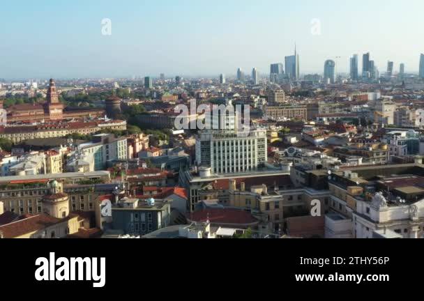 Milano from the drone in a sunny morning. Backward flight with historic ...