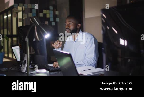 Video of african american businessman sitting at desk using computer at ...