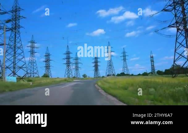 Lots of towers with high-voltage electrical wires along the road ...