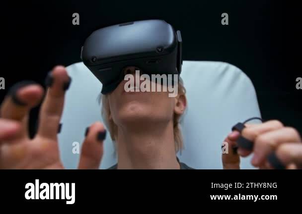 Haptic sensors hands man sitting armchair zoom out. Virtual reality ...