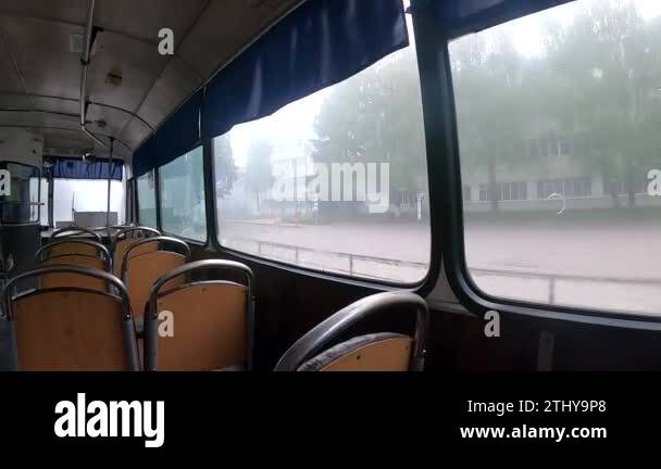 View from window of moving bus. Different buildings of city in window ...