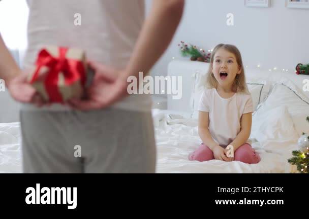 Cute surprised little girl receiving gift from her father Stock Video ...