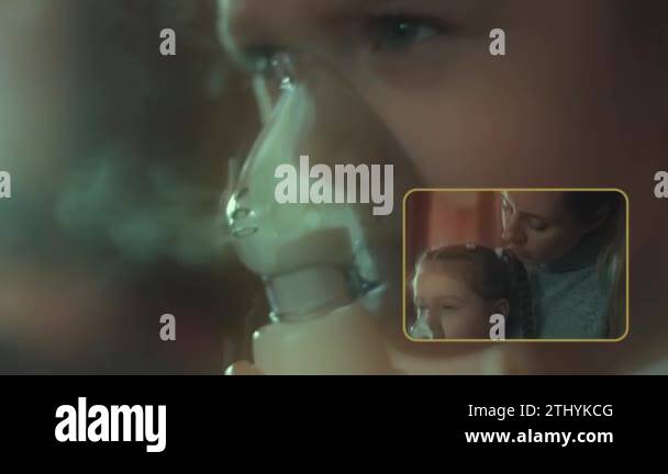 Beautiful little girl makes inhalation using a compressor inhaler while ...