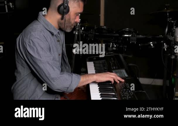 Musician man playing the electric piano in a recording studio. Music ...