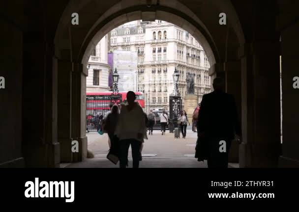 LONDON - May 18, 2022: People in silhouette walking through entrance ...