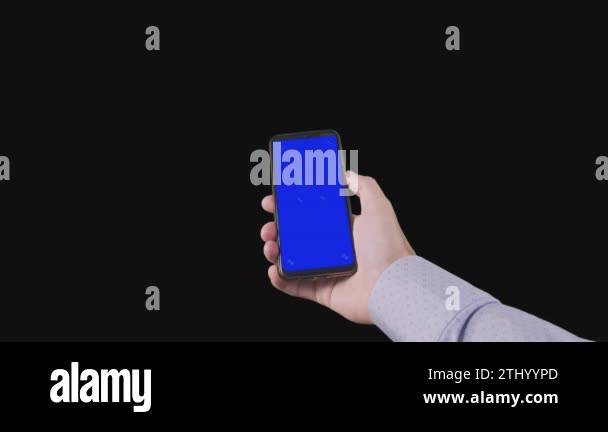Male hand holding a smartphone with a blue screen with markers on alpha ...