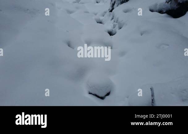 Close shot of the bottom of a mountain gorge covered with snow. Large ...