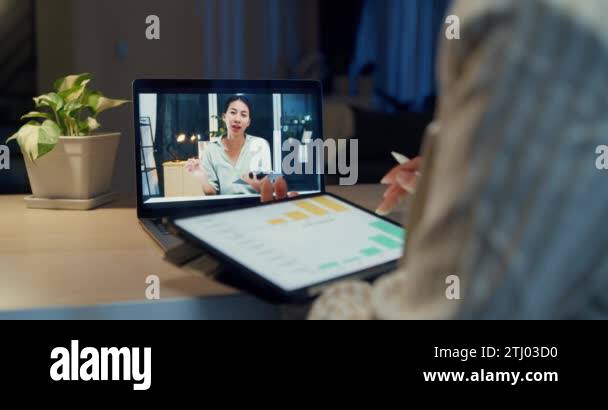 Young Asian businesswoman wear formal sit in front of desk with tablet hold stylus focus on ...