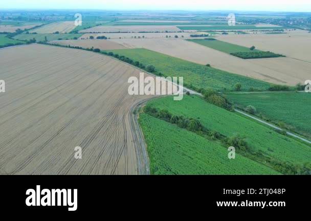 A narrow high-speed highway with fast modern hurrying cars passes ...