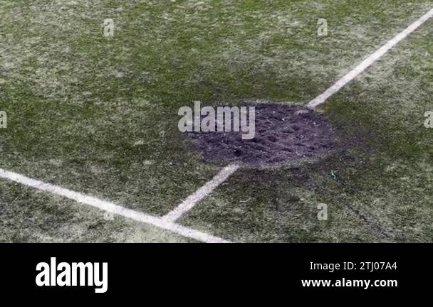 A hole in the ground from a cannon shell explosion filled with fresh ...