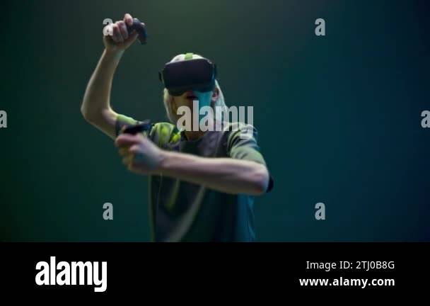 Youngster man practicing exercising using VR headset. Concentrated ...