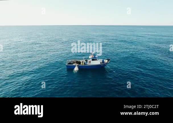 Effective team work of fisherman crew pulling out trawl with sardines ...