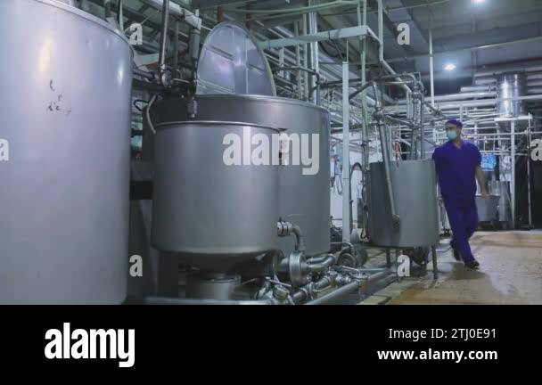 Working process in a food factory. Containers for liquids in a food ...
