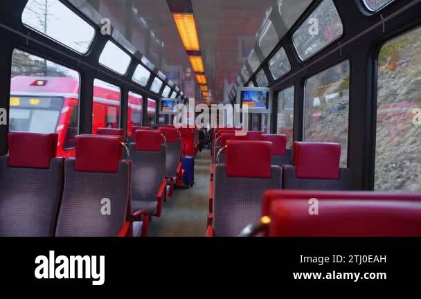 Riding a train on Zermatt Shuttle line in the Swiss Alps arriving to ...