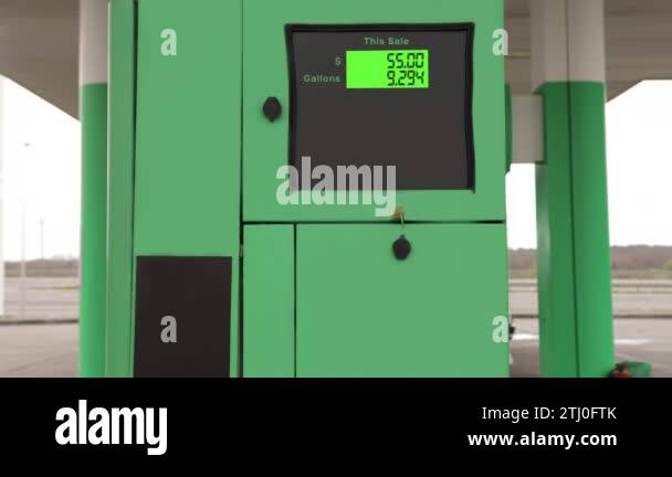 A gasoline meter counter price at a gas station, close up moment while ...