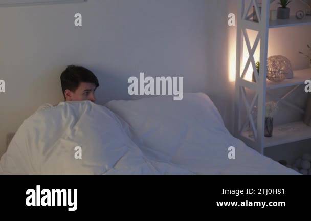 Bed fear. Sleepless night. Panic attack. Frightened disturbed guy ...