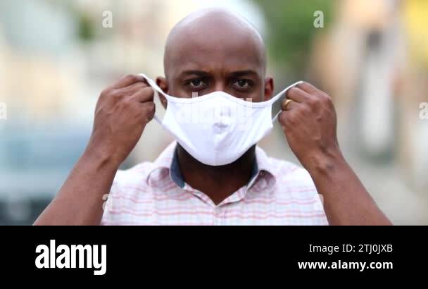 African man removing face mask feeling relief, black guy takes off ...