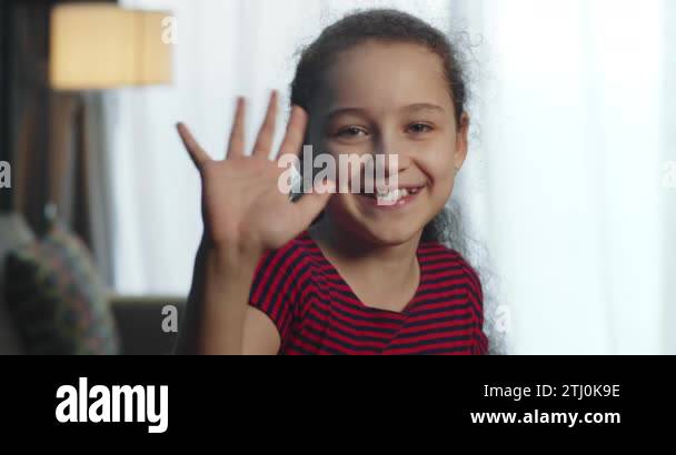 Funny smiling little girl looking at camera at home, cute child talking ...