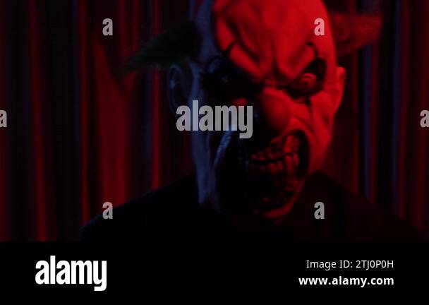 scary clown in red room horror concept . High quality 4k footage Stock ...