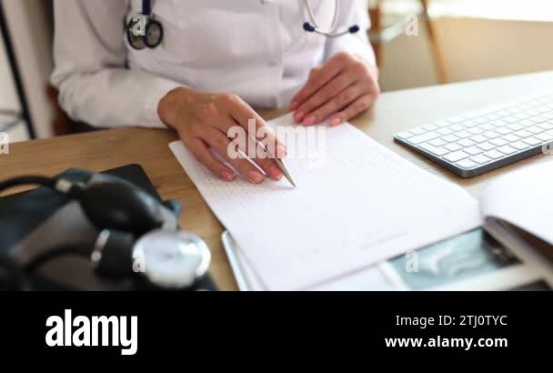 Doctor hands pointing at patient electrocardiogram chart. Help ...