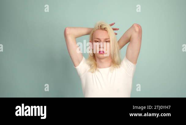 Androgyny. Transgender guy with makeup posing on background. Masculine ...