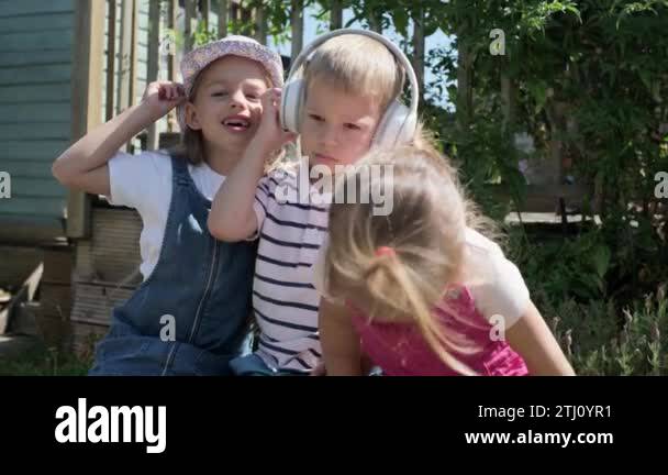 Portrait of Cute Little Three Children With Headphones Listening to ...