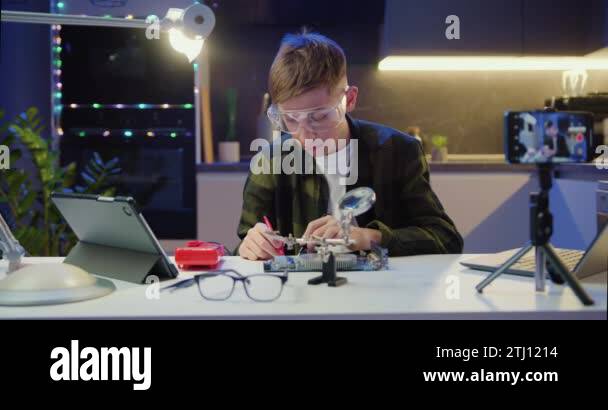 Boy try to fixing computer board in school science club. Male teen ...