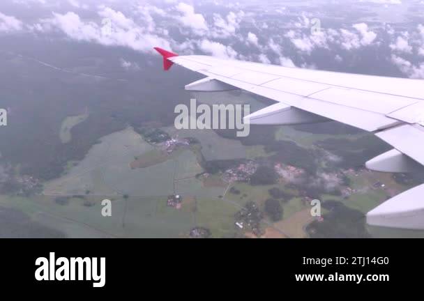 Airplane flying. Wing of an airplane flying above the clouds with ...
