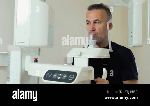 Panoramic scan of man's jaw by x-ray scanner in dental clinic. Scanner ...