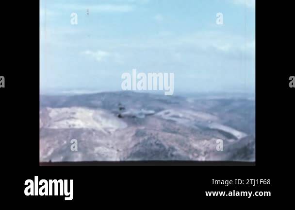 Group of fighter jets airplanes in flight over mountains. Rare archival ...
