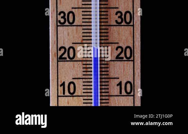 Thermometer showing falling temperature, on a scale followed with ...