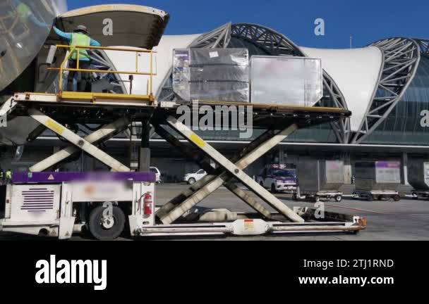 Air cargo logistic containers are loading to an cargo airplane at the ...