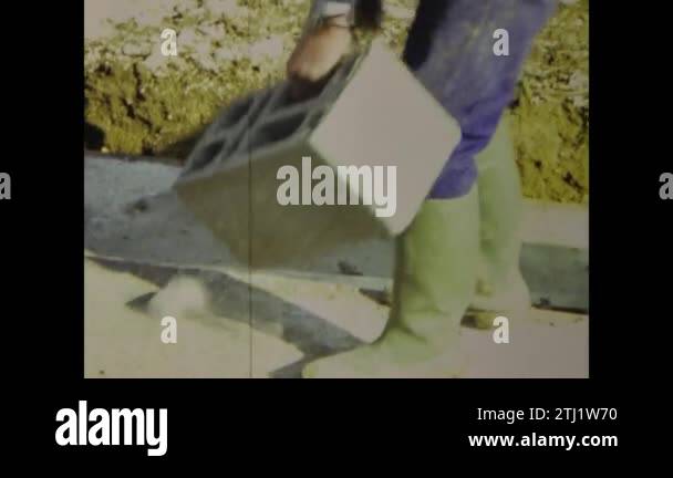 London, United Kingdom may 1972: Bricklayer builds wall in construction ...