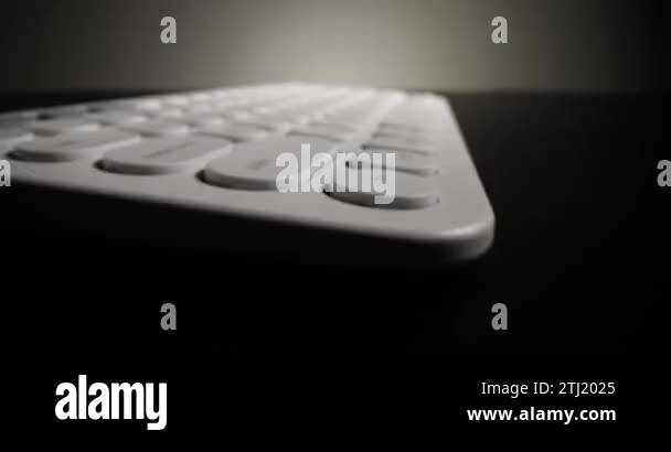 White keyboard and black letters on black background. Gaming mechanical ...