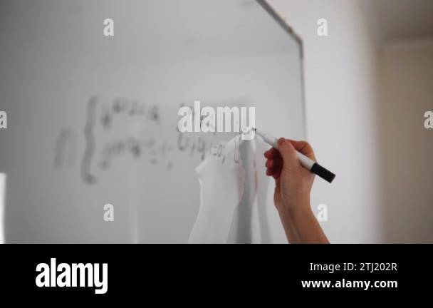 Boy student writing math equation on whiteboard. Preparation to exam ...