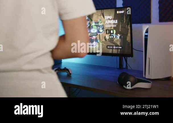 Boy walking to his gaming setup to pick up his PS5 controller and ...