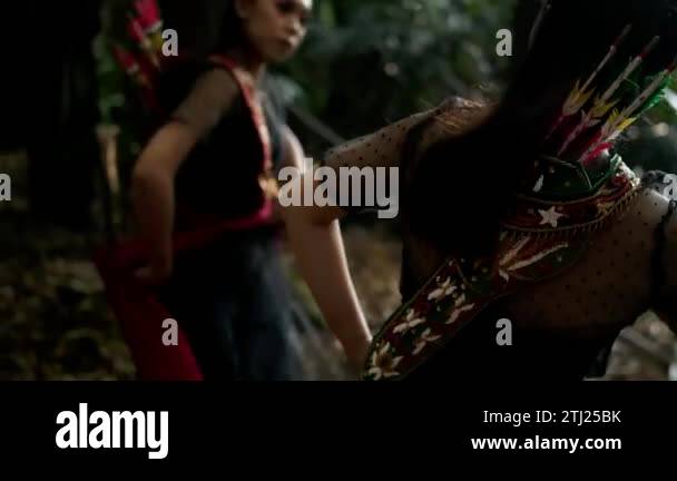 Two warriors fighting each other in the forest with a sword and an ...